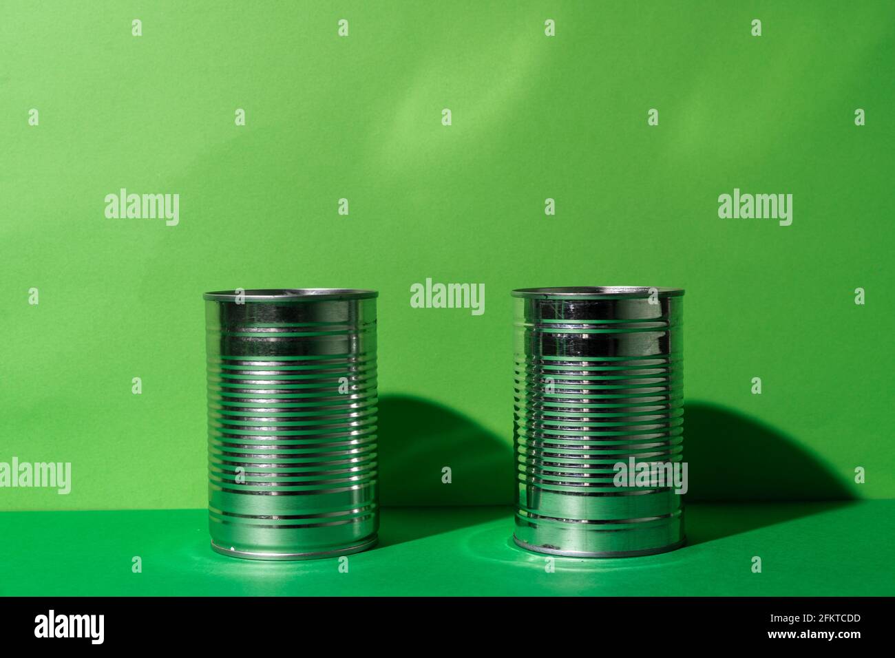Canned food tin on green studio background Stock Photo - Alamy