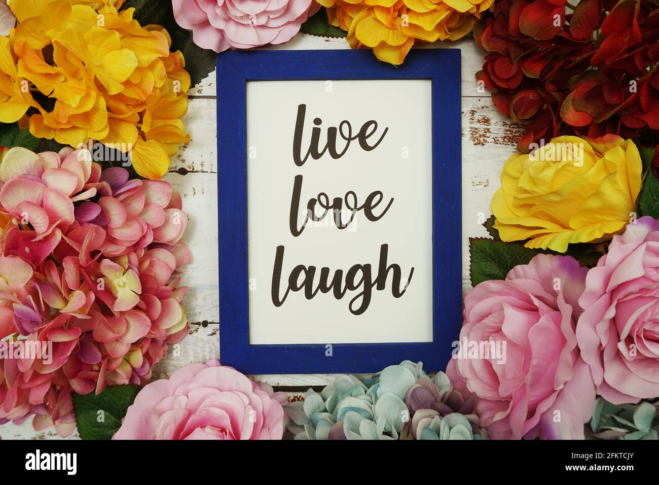 Live Love Laugh Card with colorful flowers border frame on wooden ...