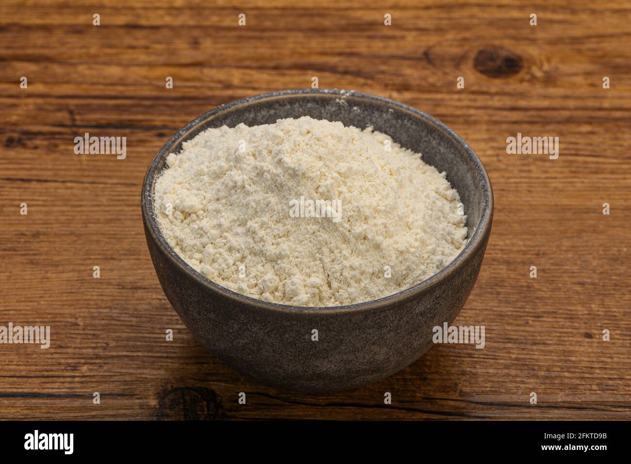 Wheat flour heap in the bowl for cooking Stock Photo - Alamy
