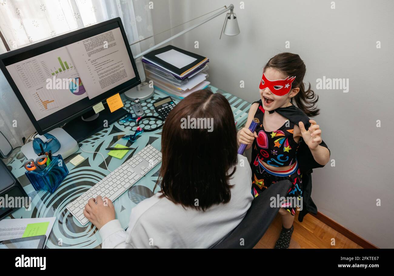 Woman working from home with her daughter interrupting her Stock Photo ...