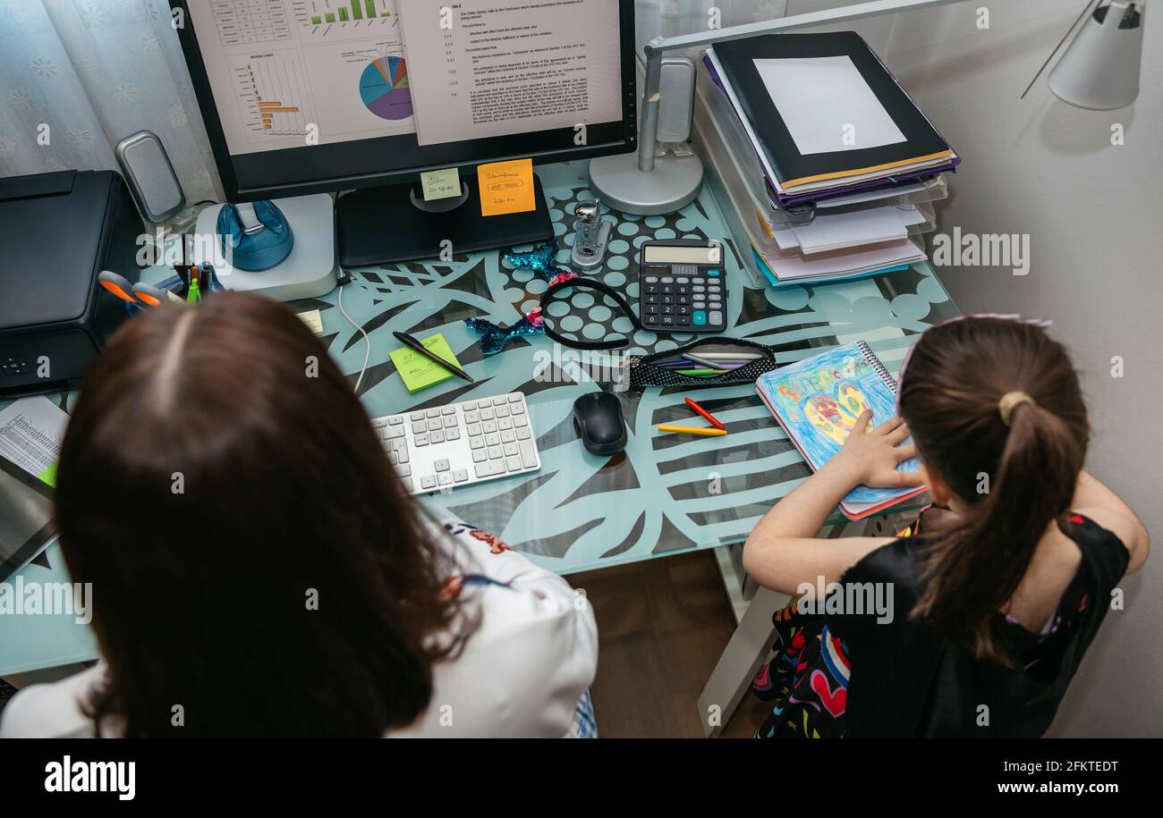Woman teleworking with her daughter drawing Stock Photo - Alamy