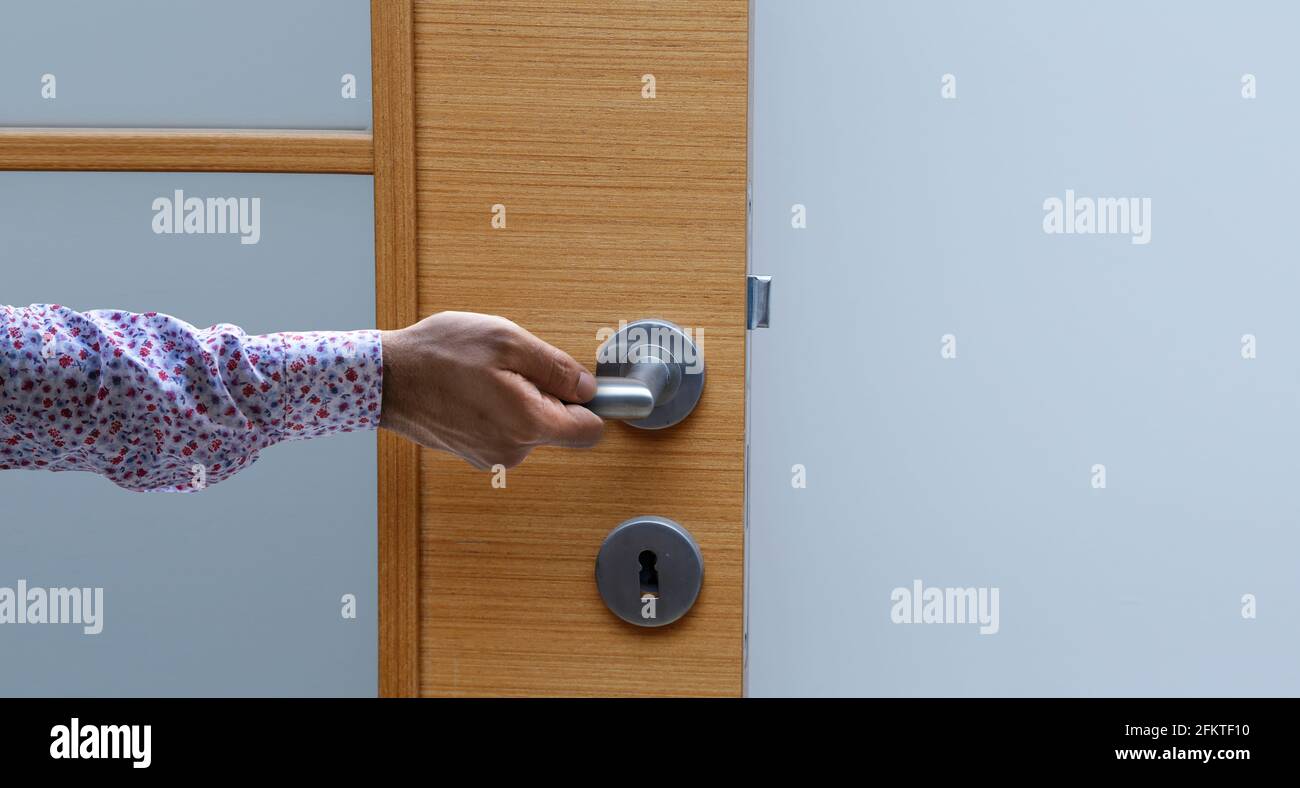male hand holding the door handle Stock Photo - Alamy