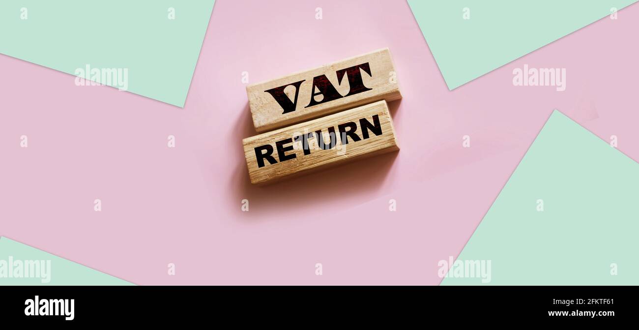 VAT return text Value Added Tax return on wooden blocks on pink ...