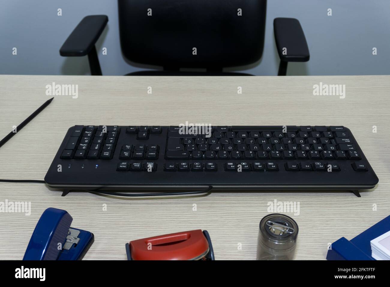 Closeup shot of an office desk with a computer keyboard and office ...