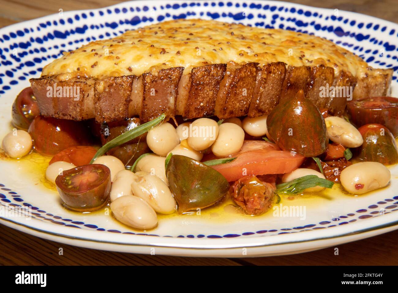 A delicious plate of a Rarebit pork chop with summer bean salad Stock ...