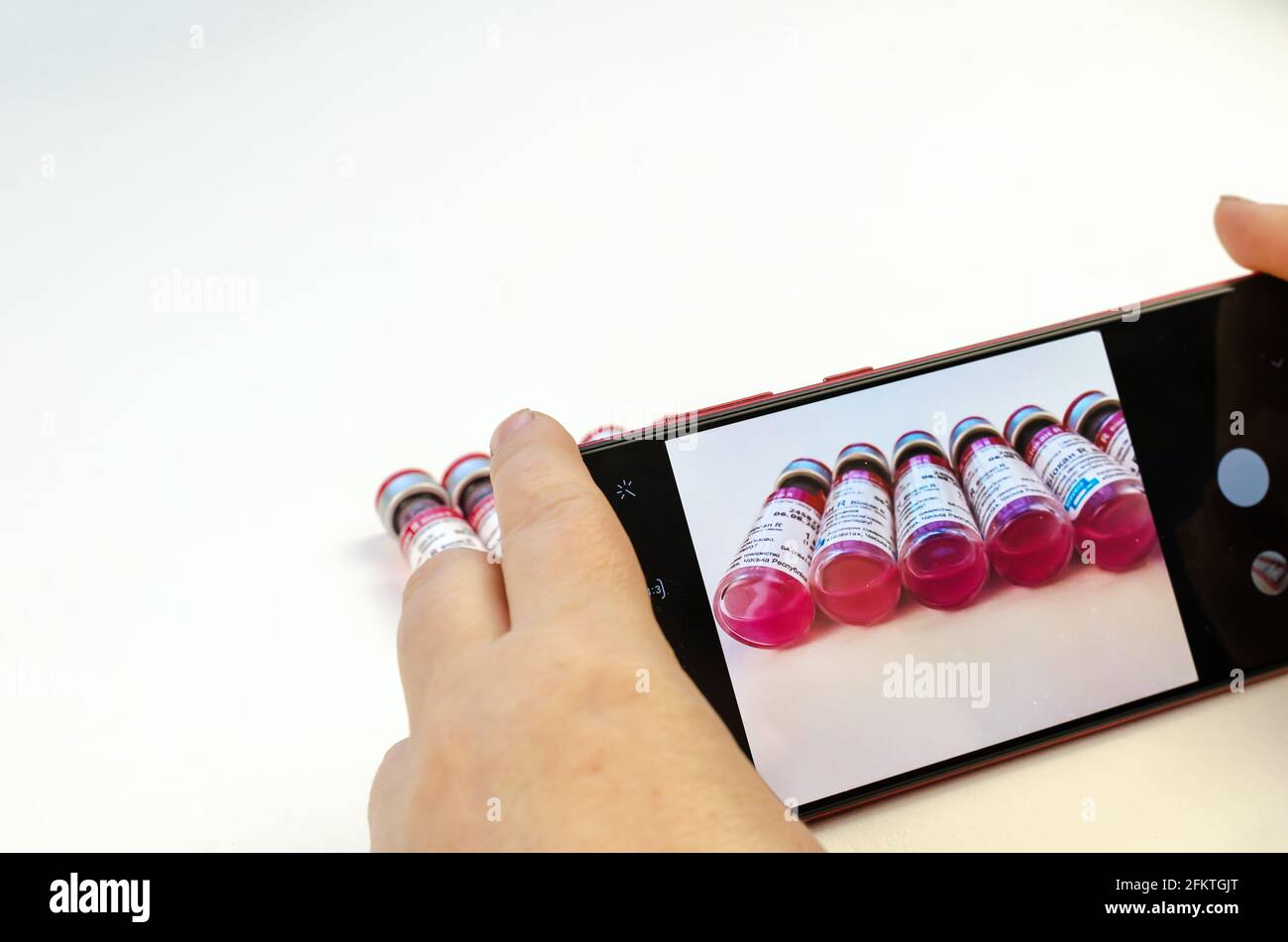 Woman taking pictures by smartphone Animal rabies vaccine Biocan R from ...