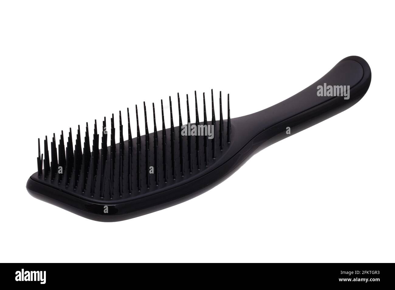 Closeup of a stylish new black hair brush isolated on white background ...