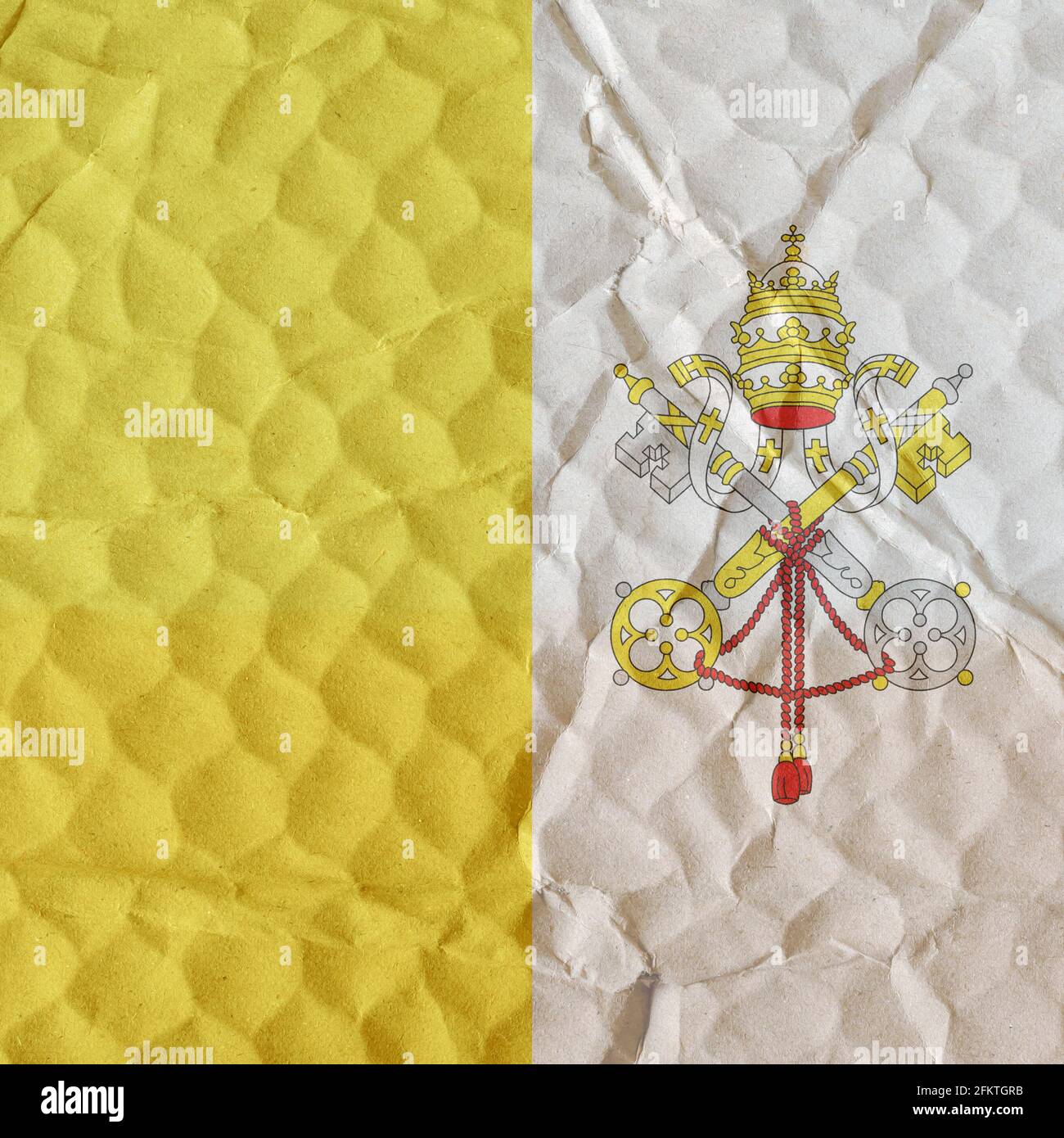 Yellow and white Vatican flag on an uneven textured surface. The ...