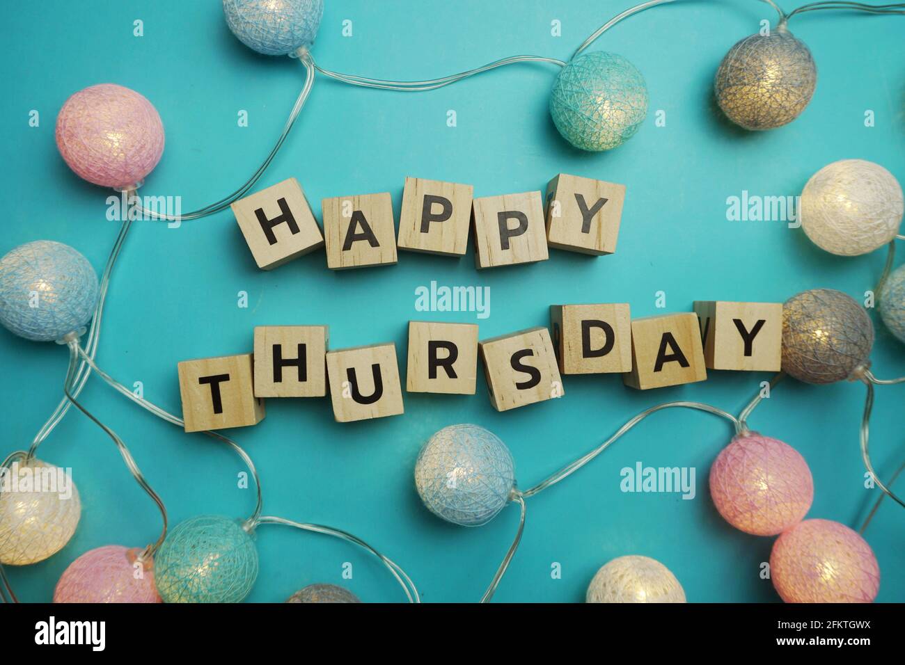 Happy Thursday alphabet letter with LED Cotton ball Decoration on blue ...