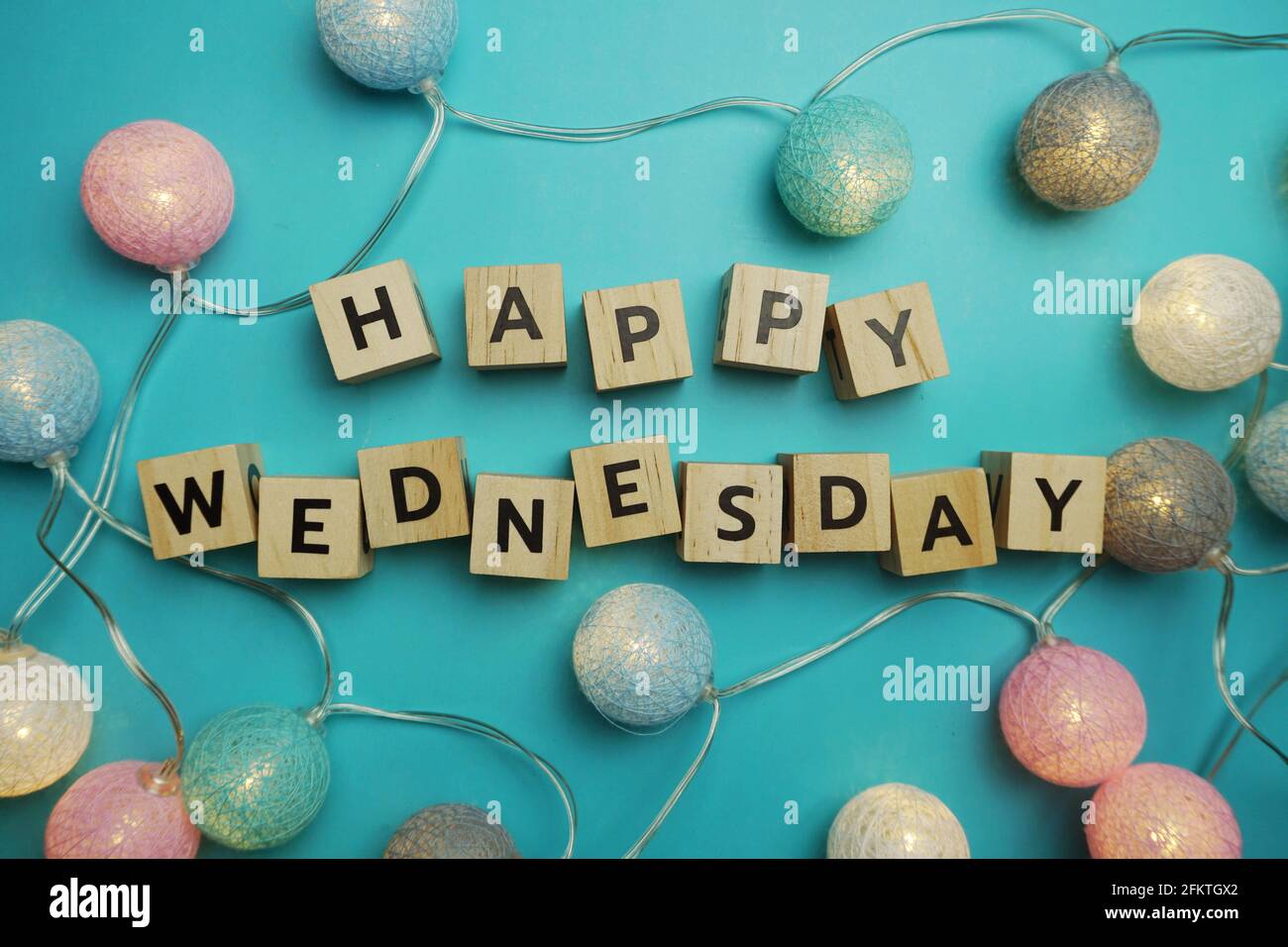 Happy Wednesday alphabet letter with LED Cotton ball Decoration on blue ...