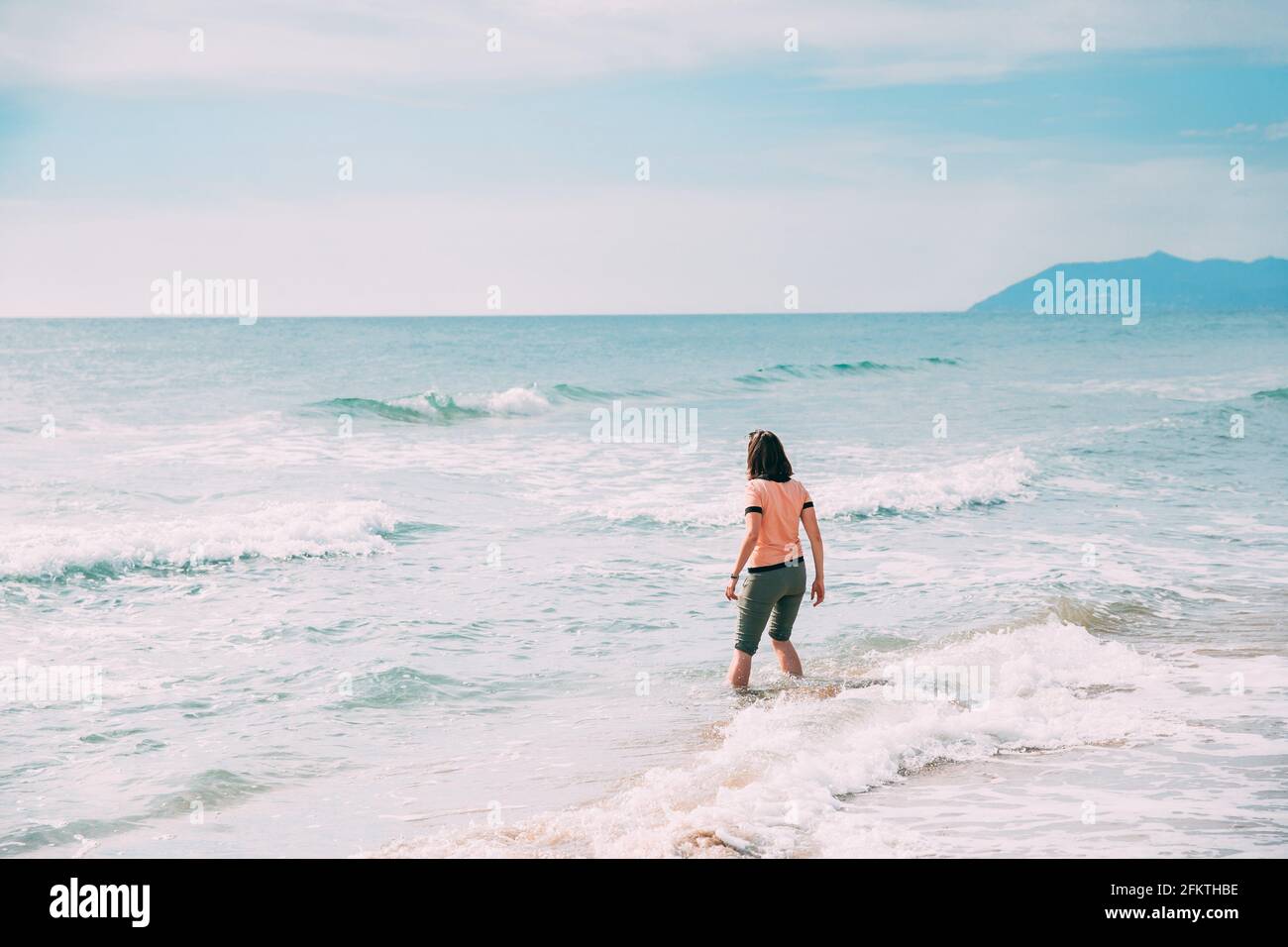 Lady walking into the sea hi-res stock photography and images - Alamy
