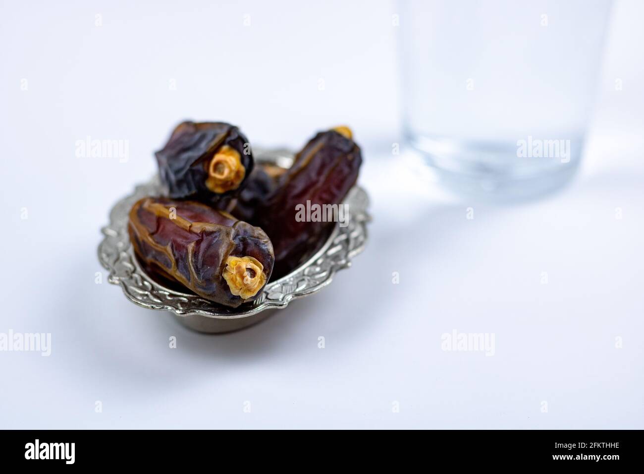 Selective focus of dates in focus on white background Stock Photo - Alamy