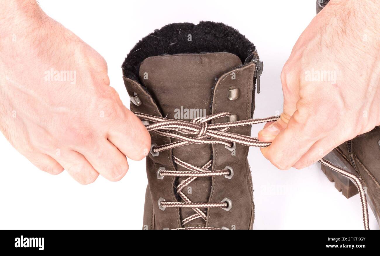 Tying laces of a hiking boot, isolated on white Stock Photo - Alamy