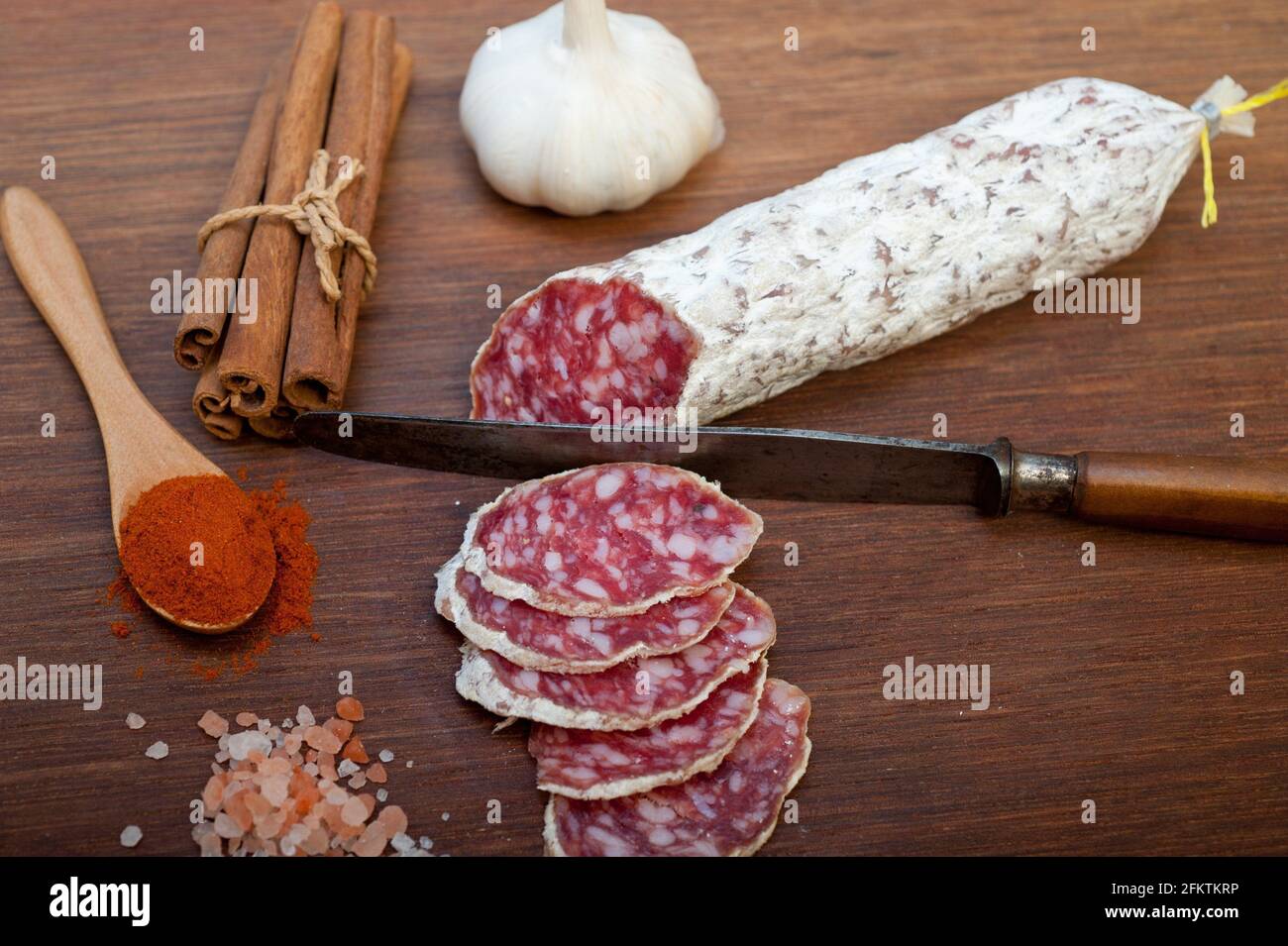 traditional Italian salame cured sausage sliced on a wood board Stock ...