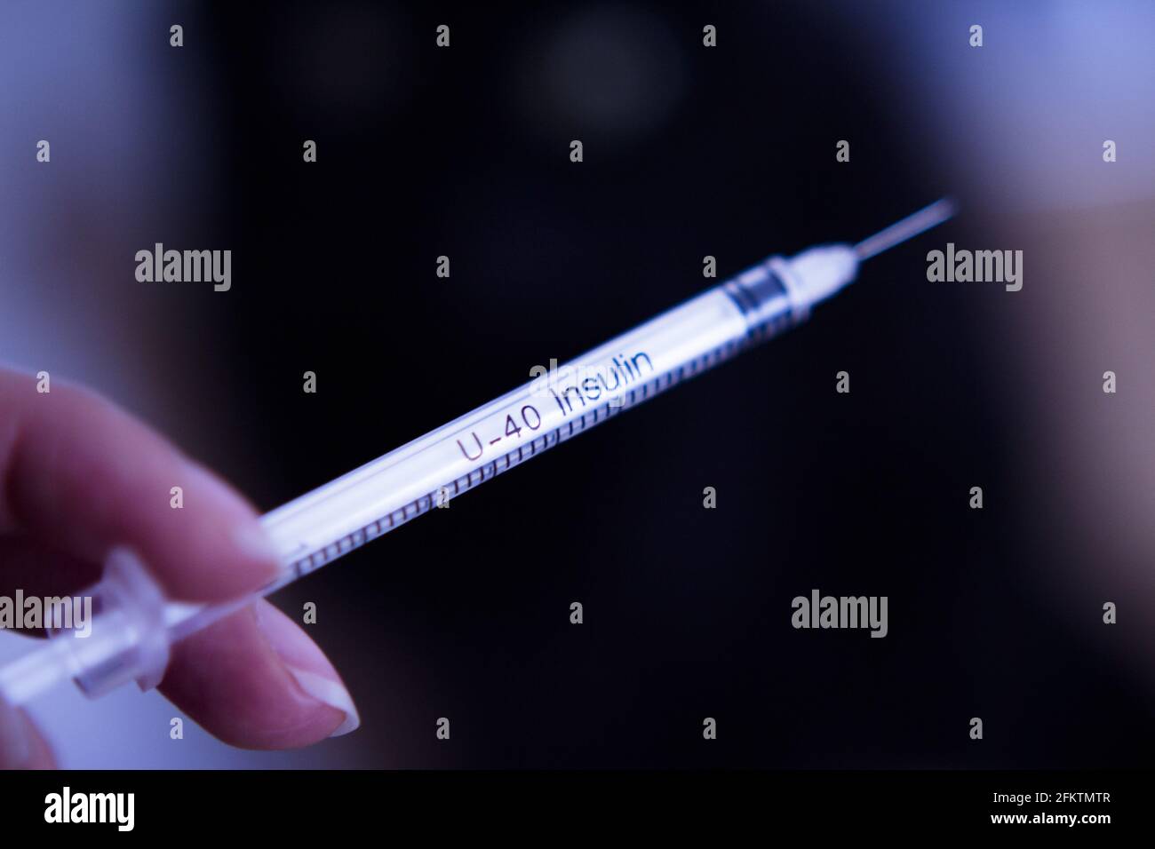 Insulin injecting syringe held by nurses hand. Copy space Stock Photo ...