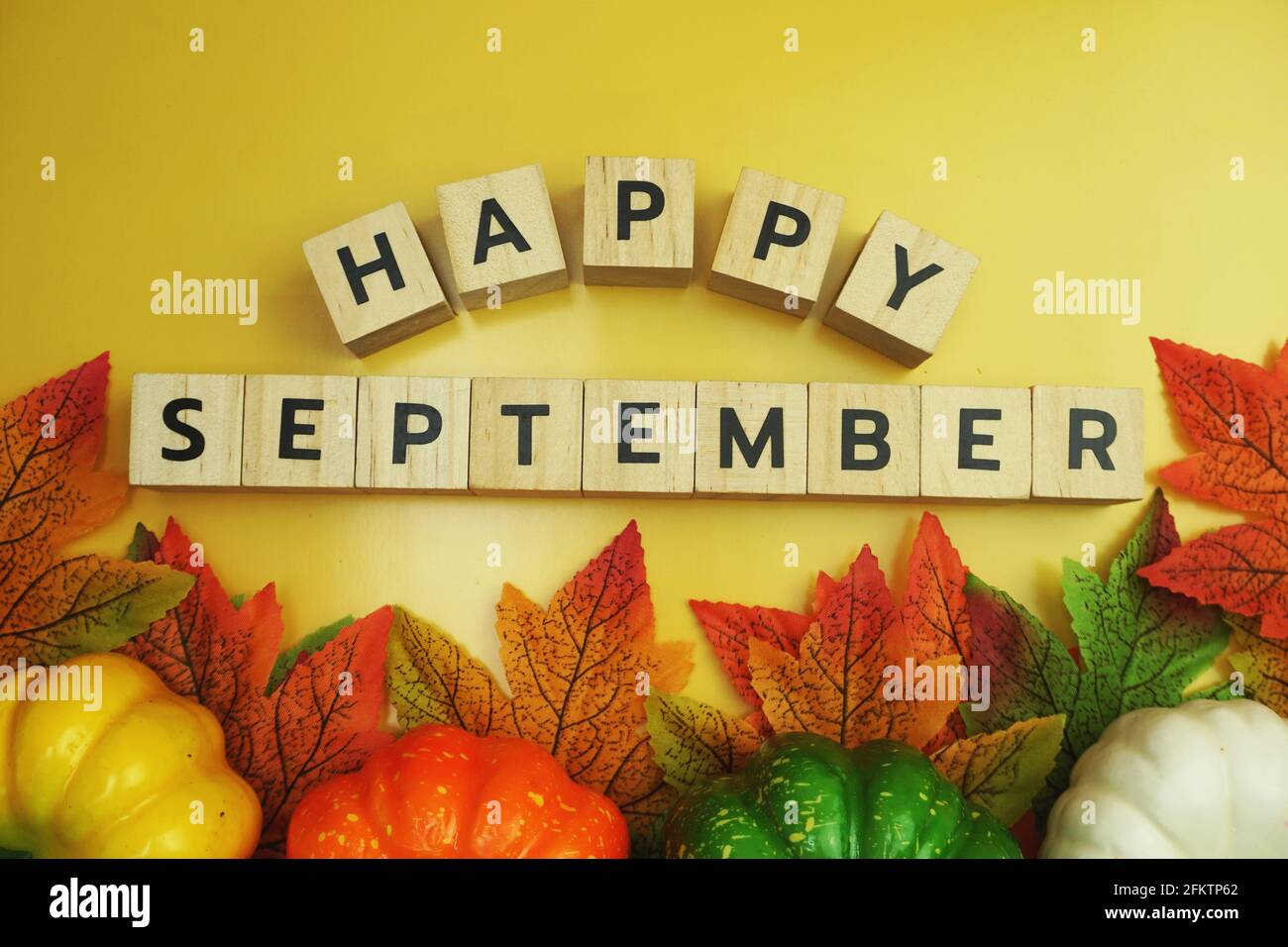Happy September alphabet letter with maple leaves frame on wooden ...