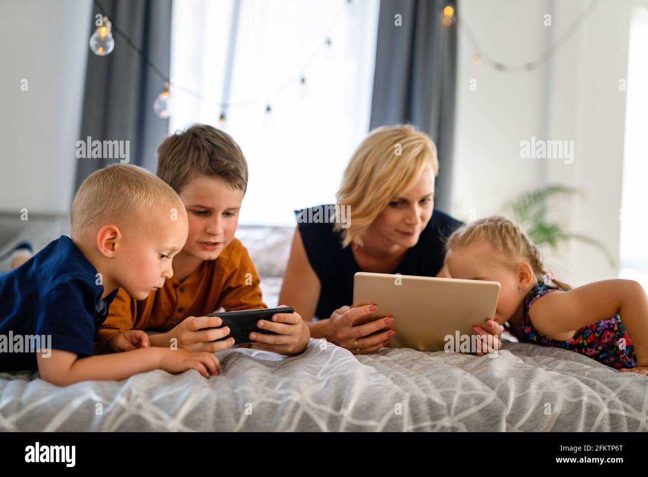Technology addicted family parent and kids use digital devices ...