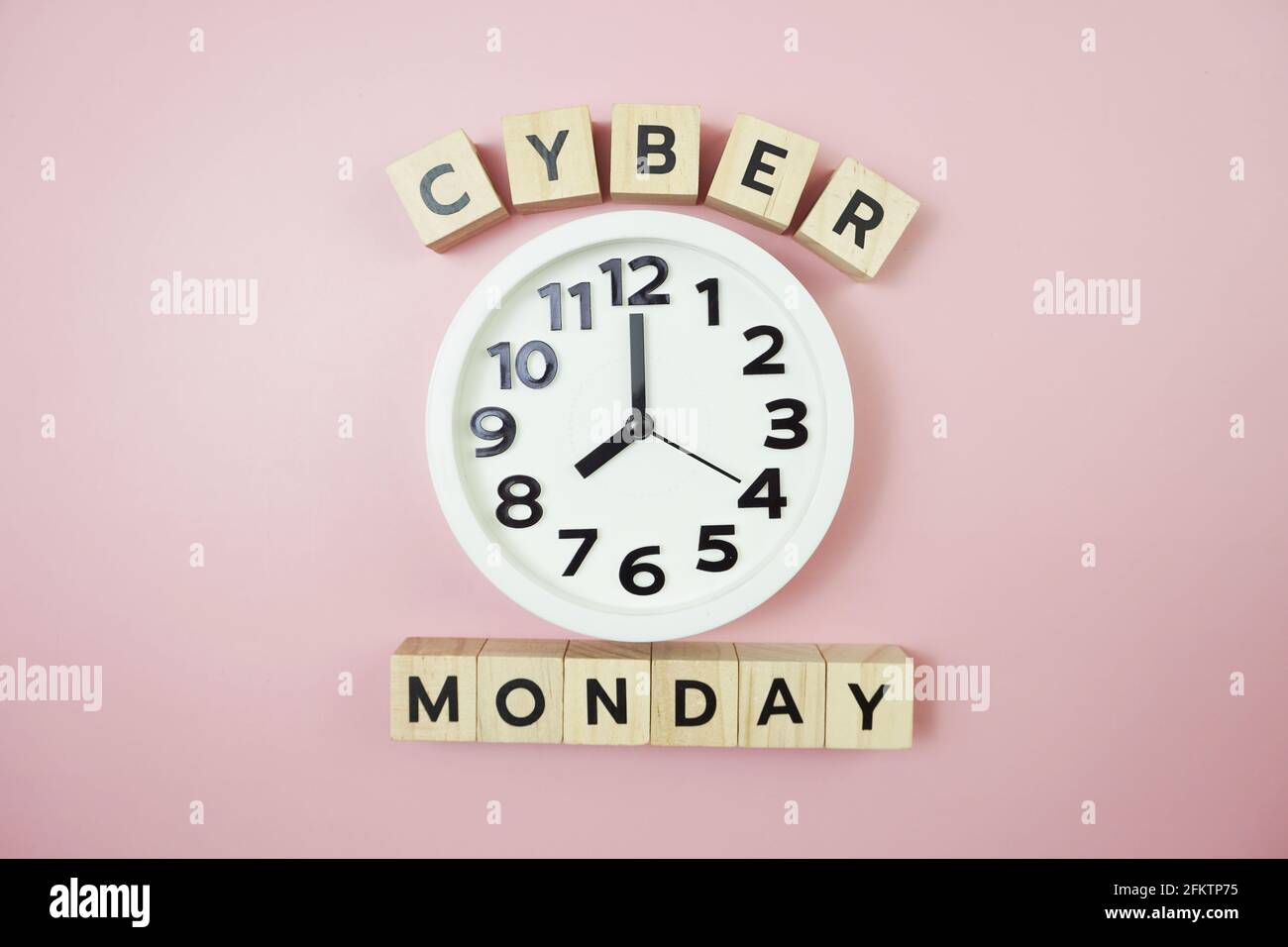Cyber Monday alphabet letters with alarm clock top view on pink ...