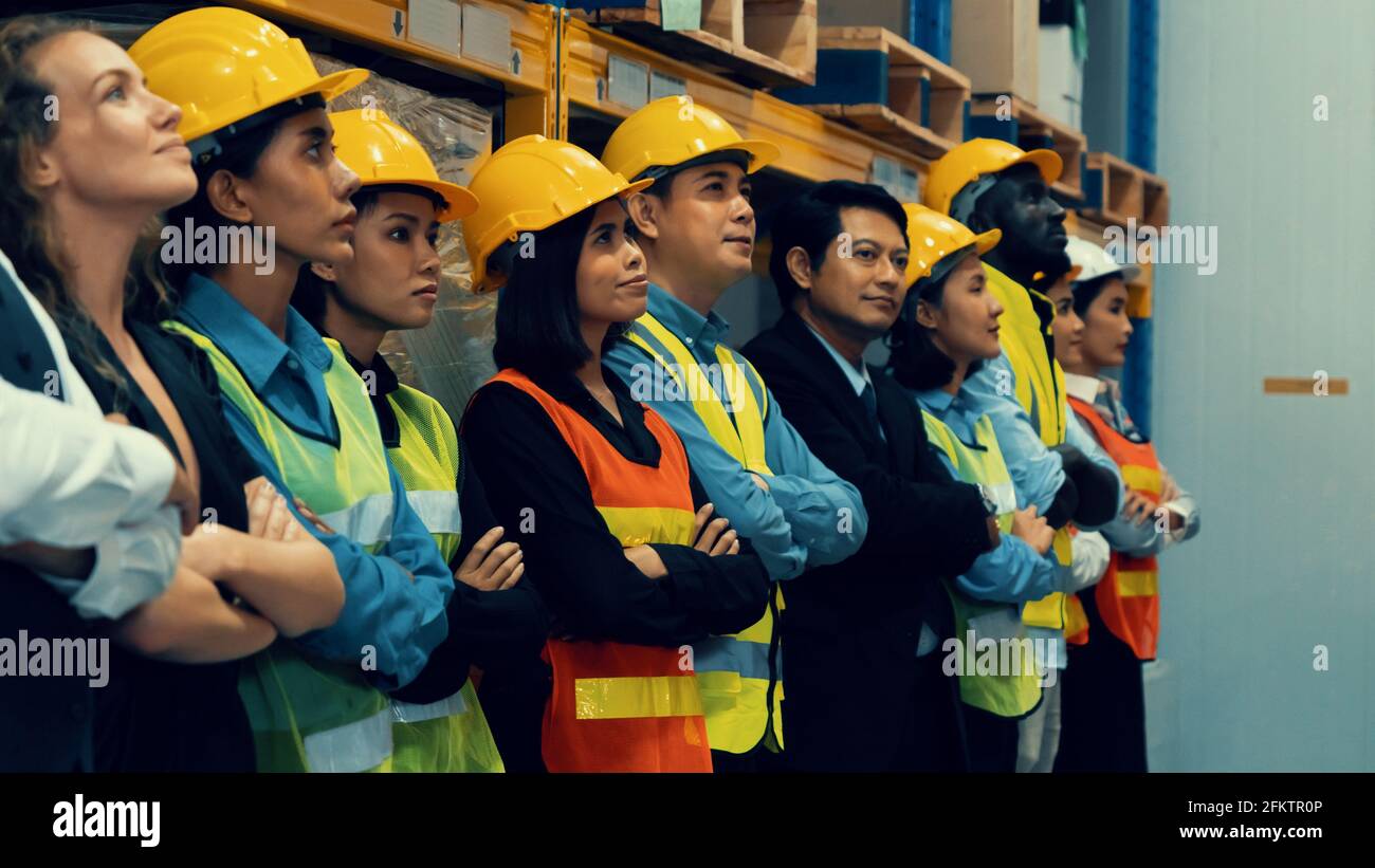 Large group of factory worker standing together in warehouse or ...
