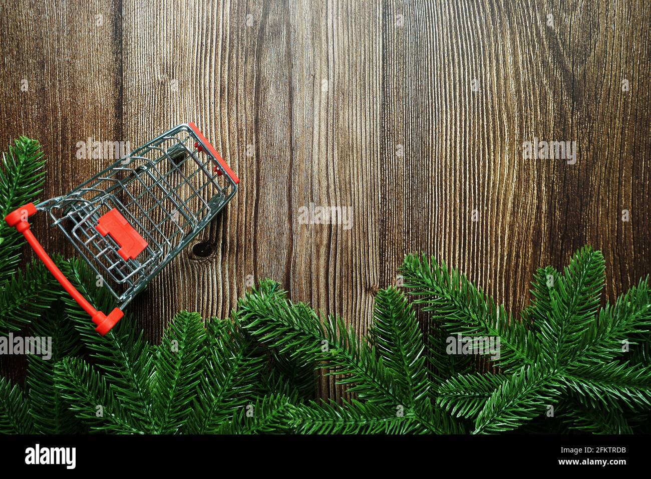 Mini Shopping Trolley with fir tree branches border frame on wooden ...