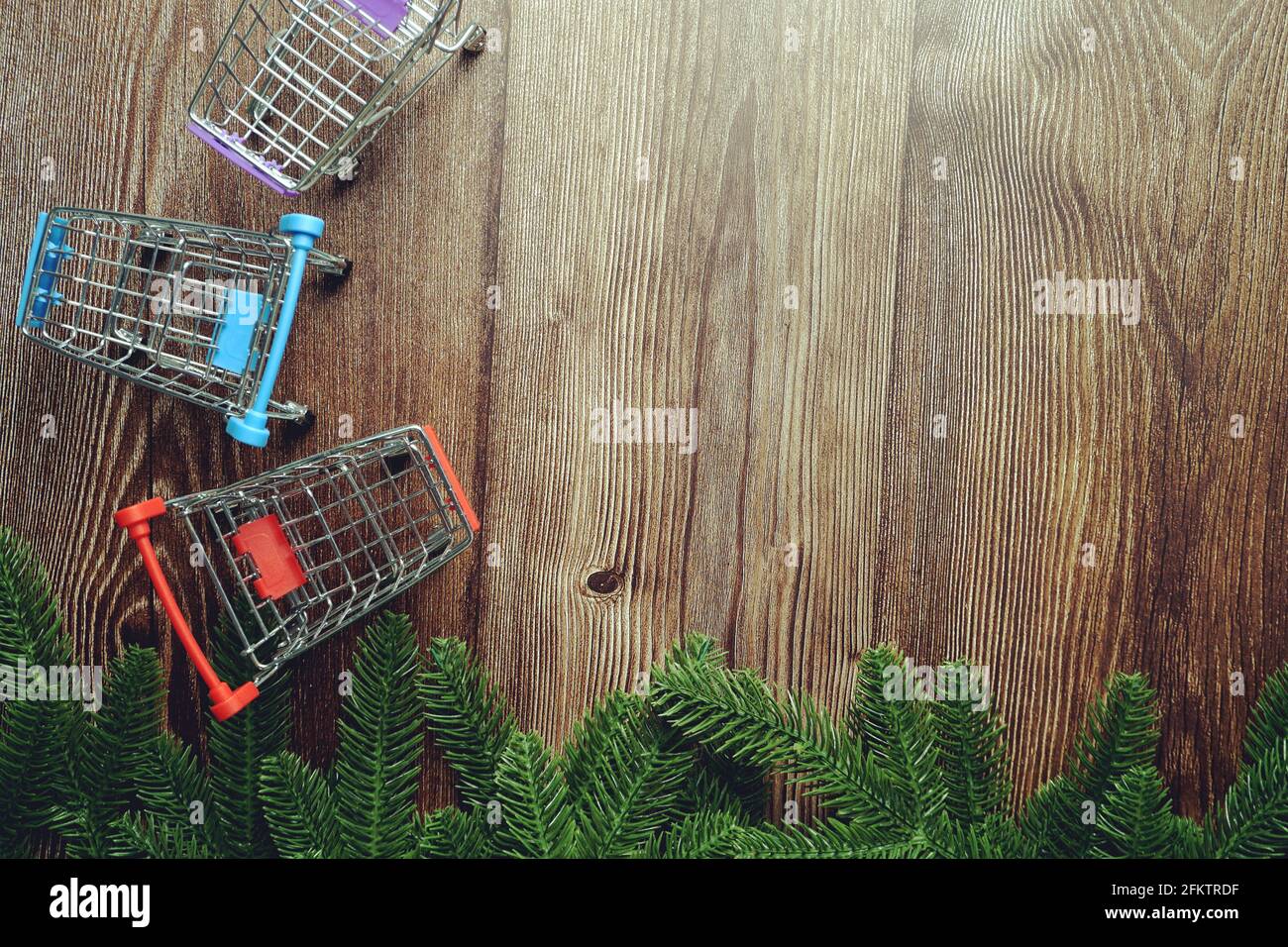 Mini Shopping Trolley with fir tree branches border frame on wooden ...