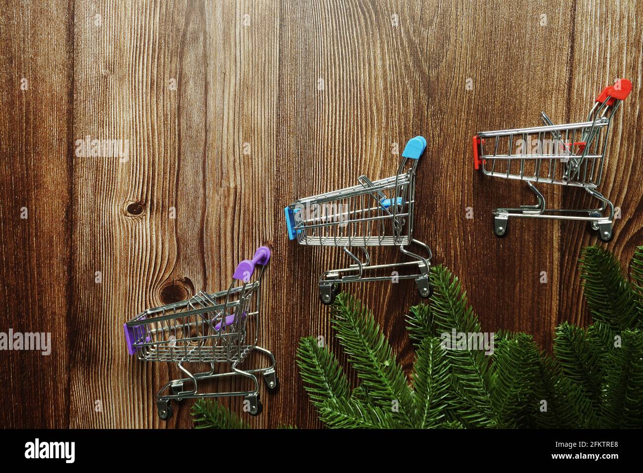 Mini Shopping Trolley with fir tree branches border frame on wooden ...