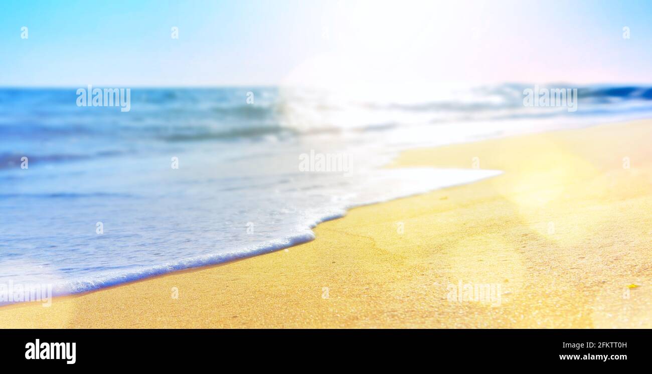 abstract summer vacation background of blurred beach sand and sea waves ...