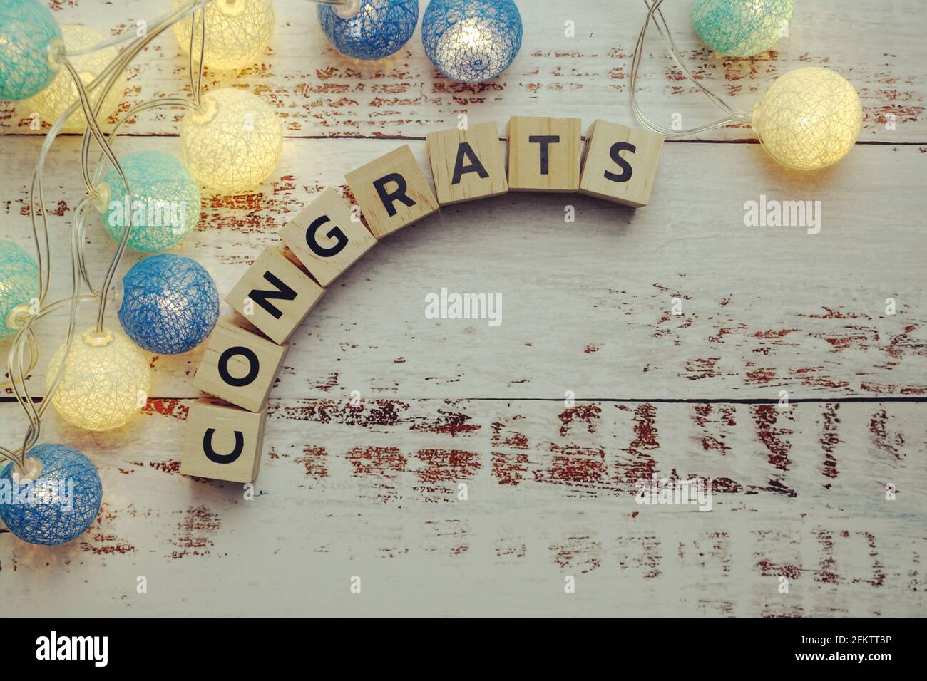 Congrats alphabet letter and LED cotton balls on wooden background ...