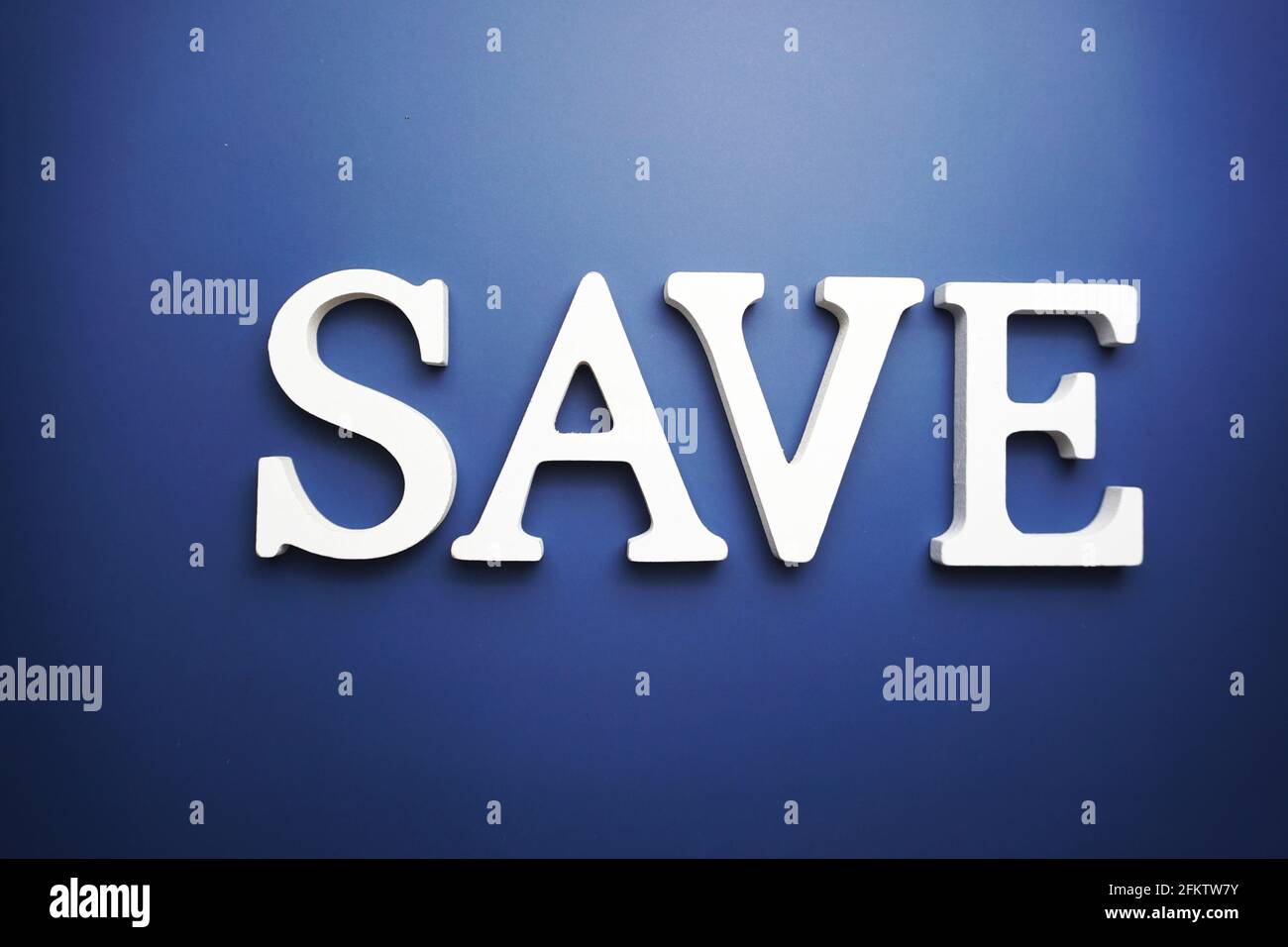 Save alphabet letter on blue background Stock Photo - Alamy