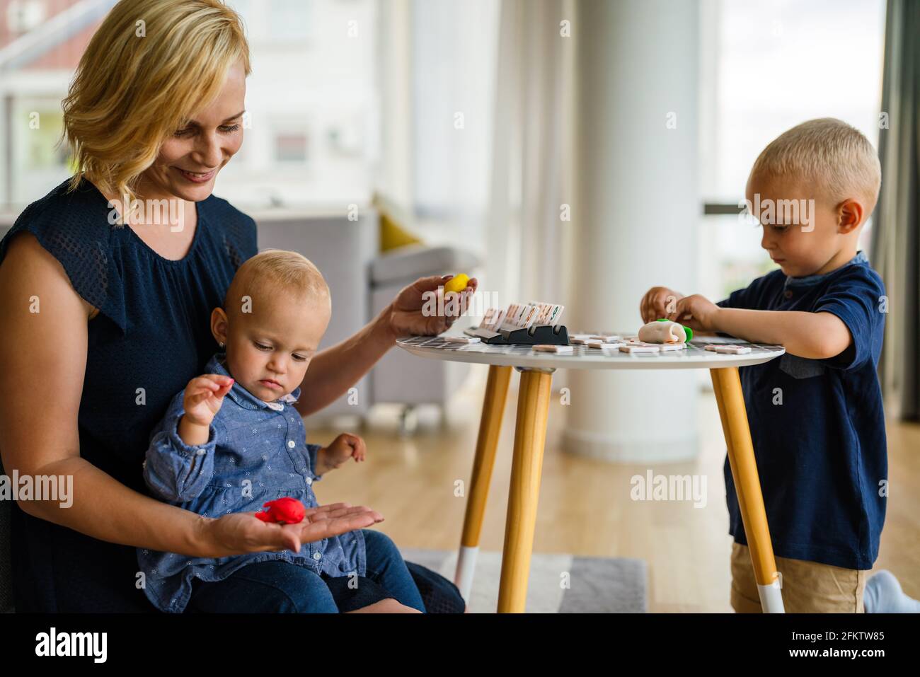 Nursery children having fun and playing with teachers Stock Photo - Alamy