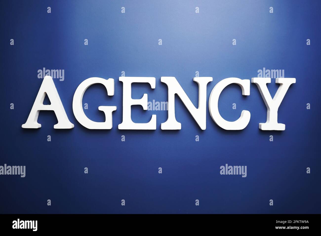 Agency alphabet letter on blue background Stock Photo - Alamy