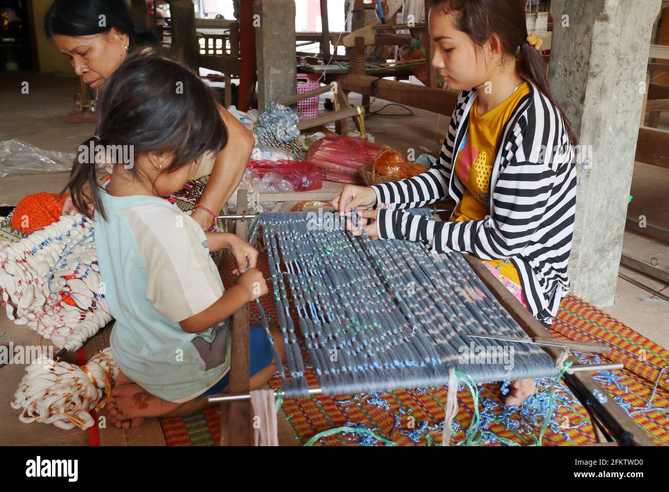 Child weaving asia hi-res stock photography and images - Alamy