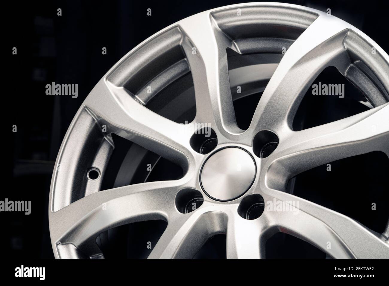 silver alloy wheel close up on a black background Stock Photo - Alamy