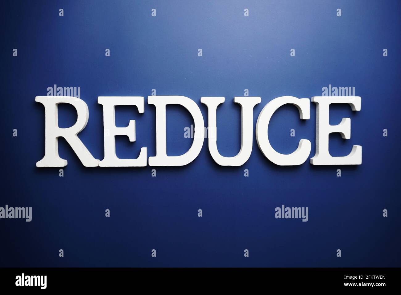 Reduce alphabet letter on blue background Stock Photo - Alamy