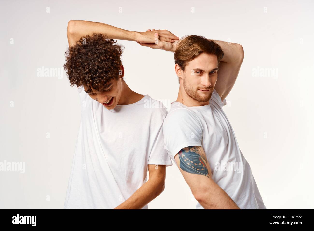 two funny friends in white t-shirts laughing positive emotions Stock ...