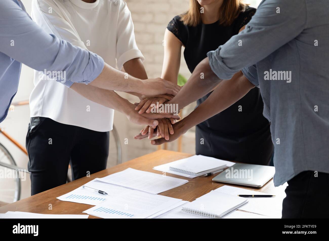 Close up group of multiracial people joining hands together Stock Photo ...