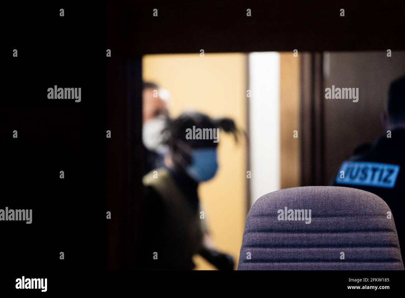 Cologne, Germany. 04th May, 2021. The accused is led in handcuffs into ...