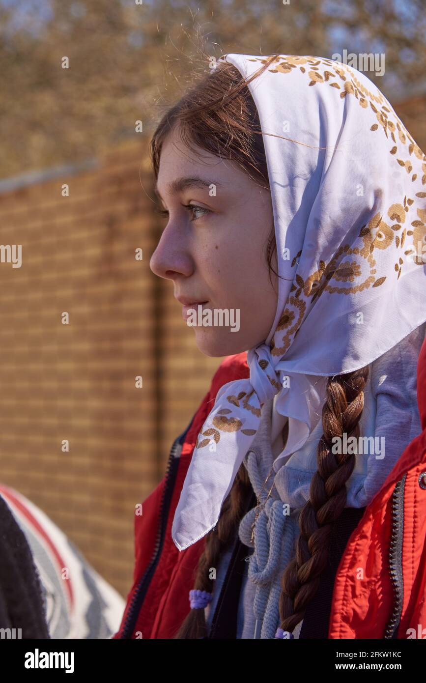 A teenage girl in a red jacket and a white scarf Stock Photo - Alamy