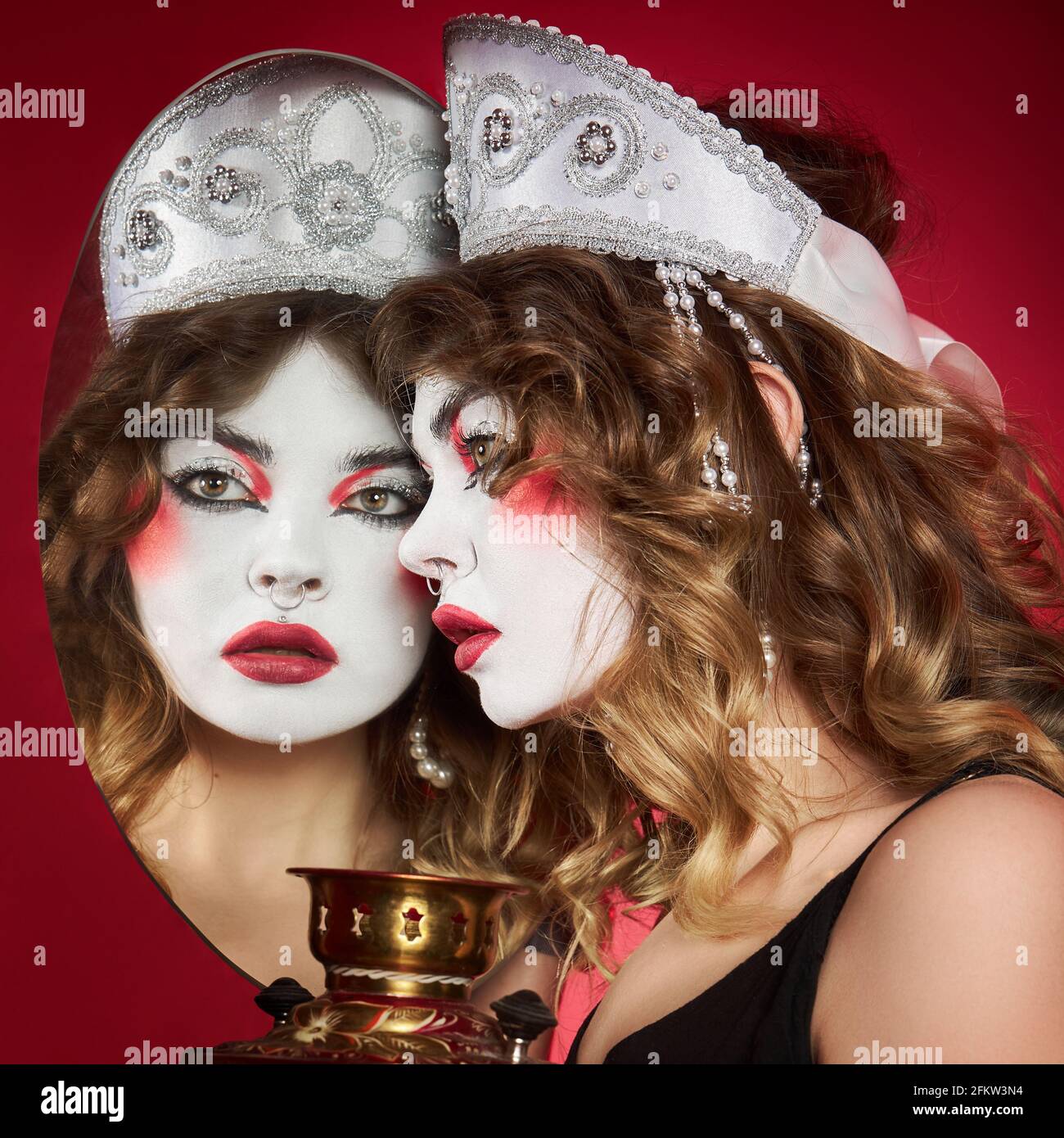 Fashion Russian woman in a kokoshnik with samovar on red background ...