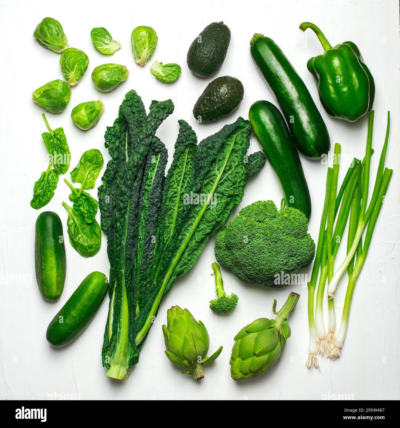 Green vegetables and herbs assortment on a white background. Flat lay ...