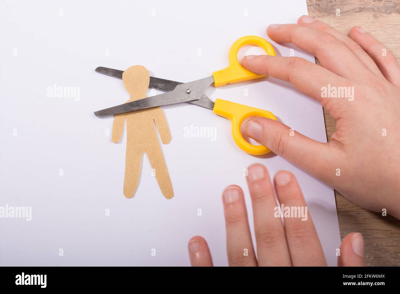 Scissors cut Paper man shape in the view Stock Photo - Alamy
