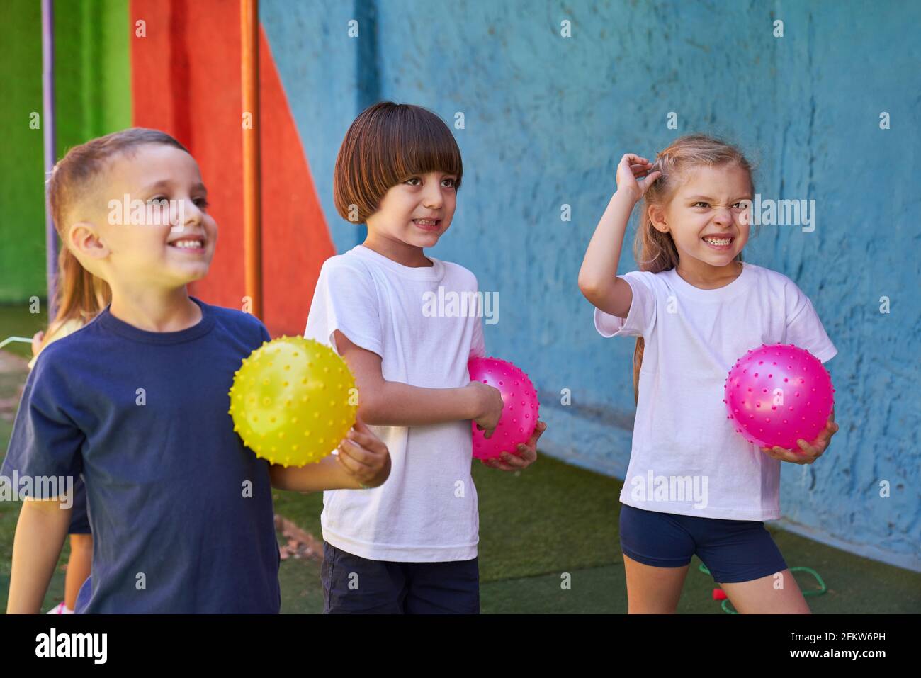 Group of kids has fun playing ball in physical education class in ...