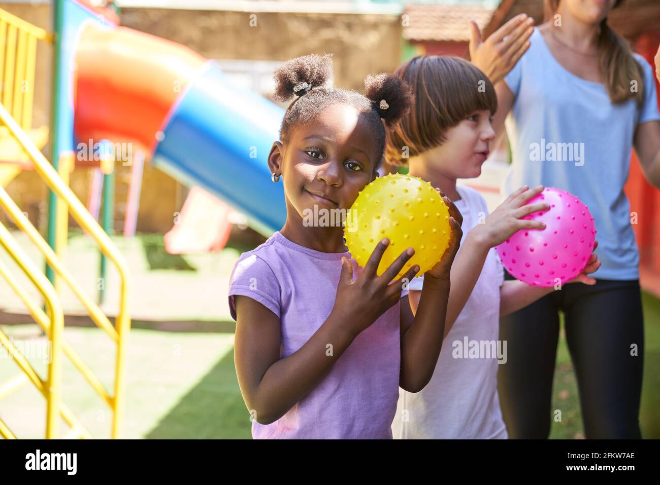 Children playing ball in physical education class with gymnastics ...