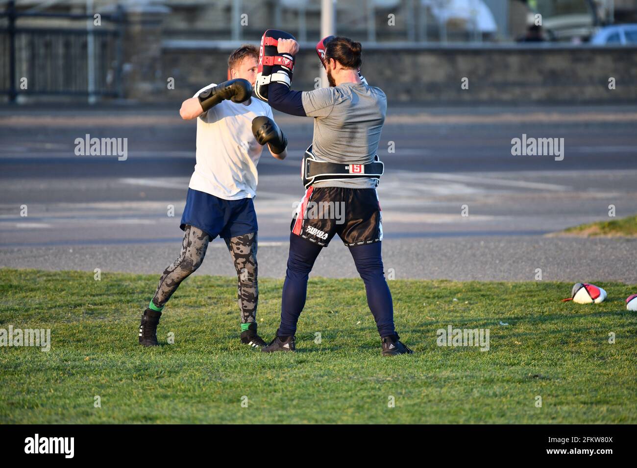 Two men training using boxing pads outdoors Stock Photo - Alamy