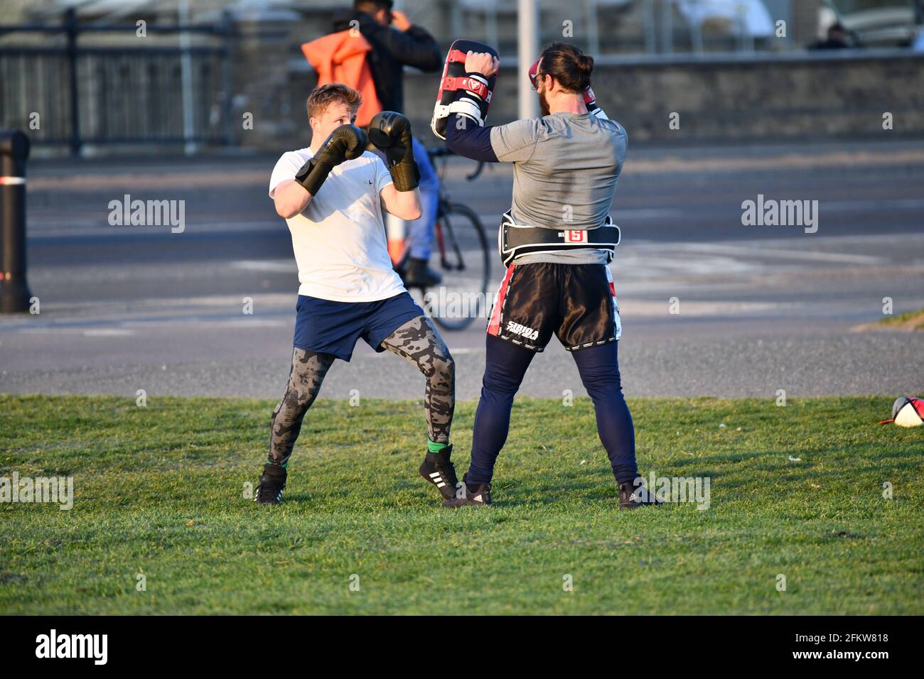 Two men training using boxing pads outdoors Stock Photo - Alamy