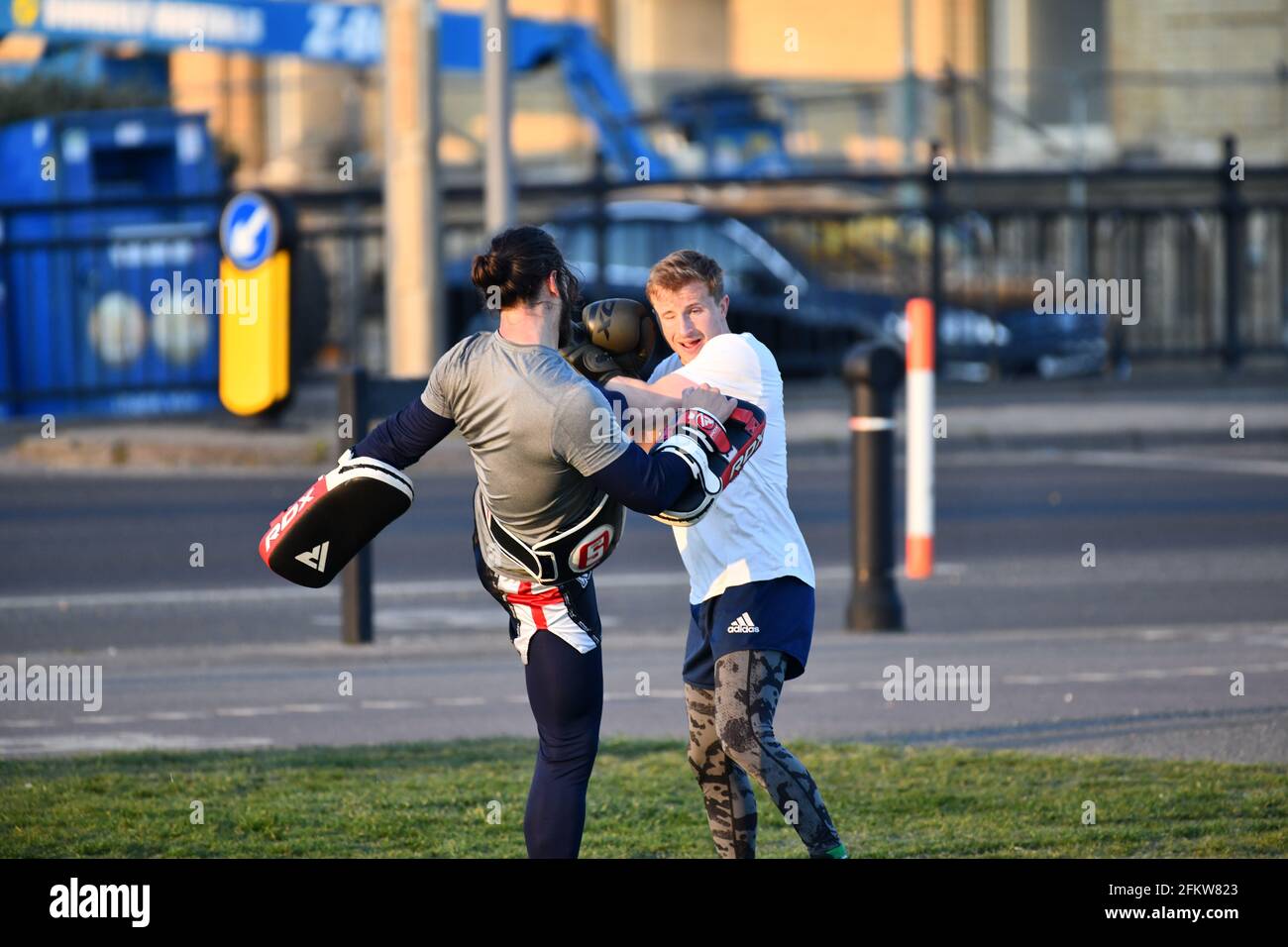 Two men training using boxing pads outdoors Stock Photo - Alamy