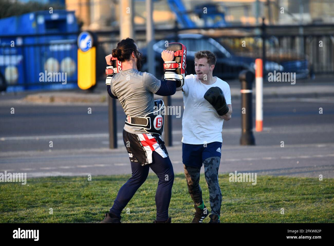 Two men training using boxing pads outdoors Stock Photo - Alamy