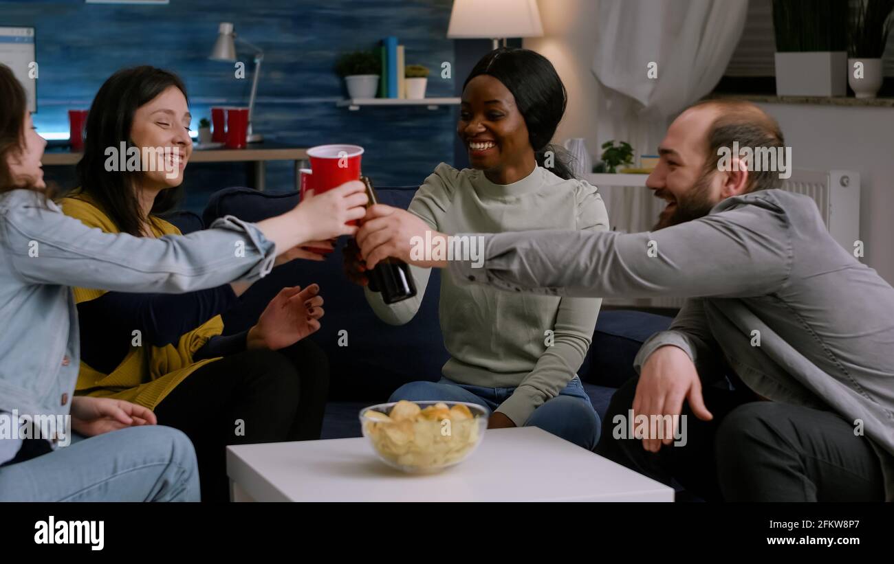 Afro american woman socialising with friends while having fun late at ...