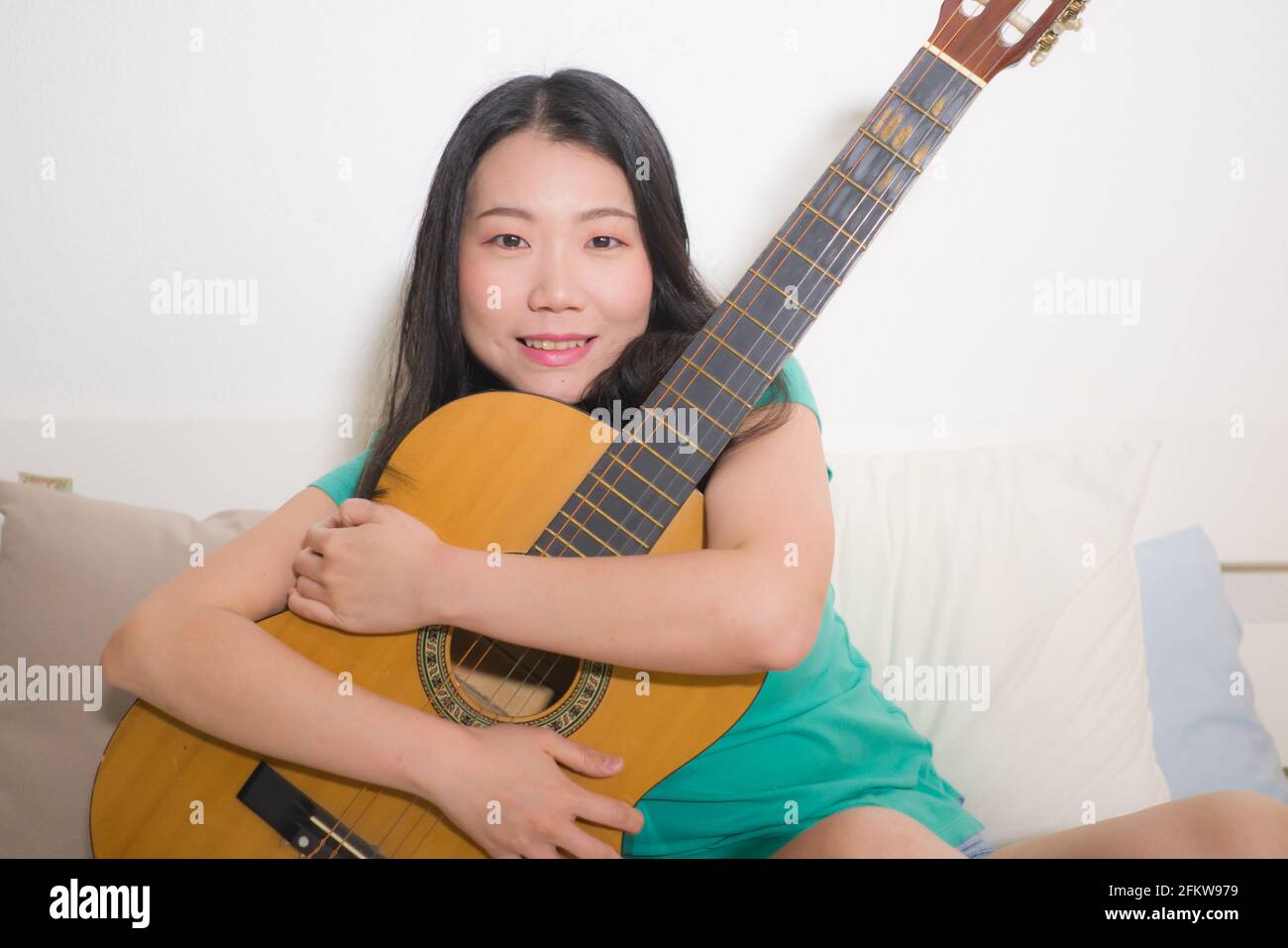 Chinese female playing guitar hi-res stock photography and images - Alamy