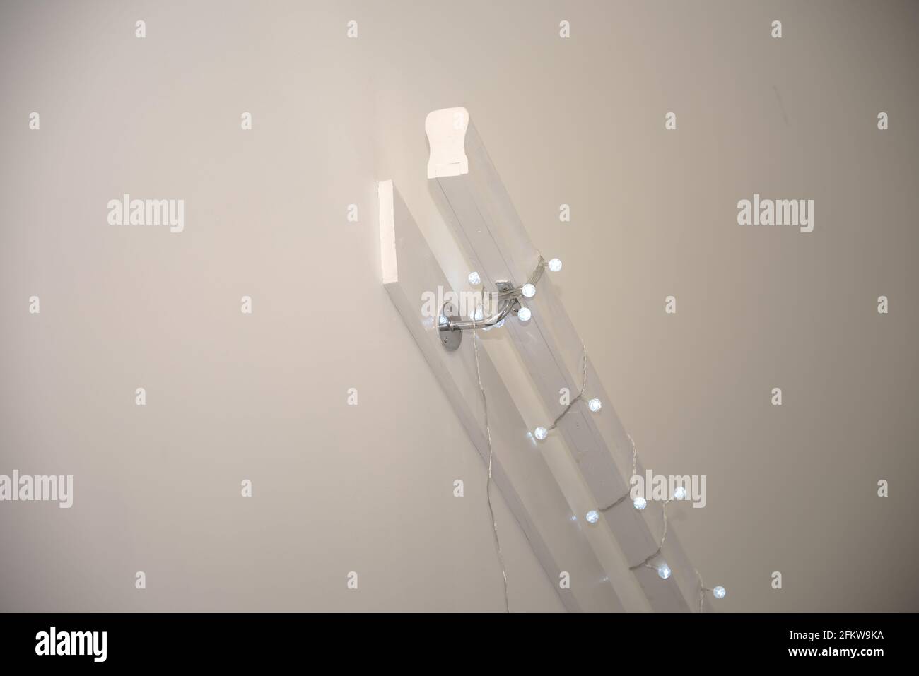 Fairy lights on a stair rail Stock Photo - Alamy